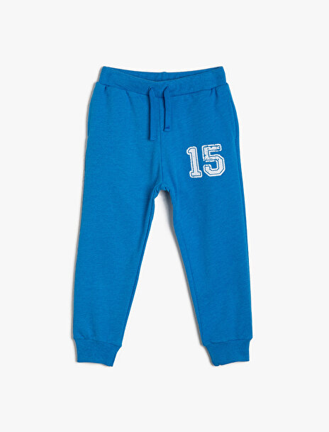 Koton Erkek Çocuk Yumuşak Tüylü Sweatshirt Kumaşından Paçası Ribanalı Baskılı Jogger Eşofman Altı Koton Erkek Çocuk Yumuşak Tüylü Sweatshirt Kumaşından Paçası Ribanalı Baskılı Jogger Eşofman Altı